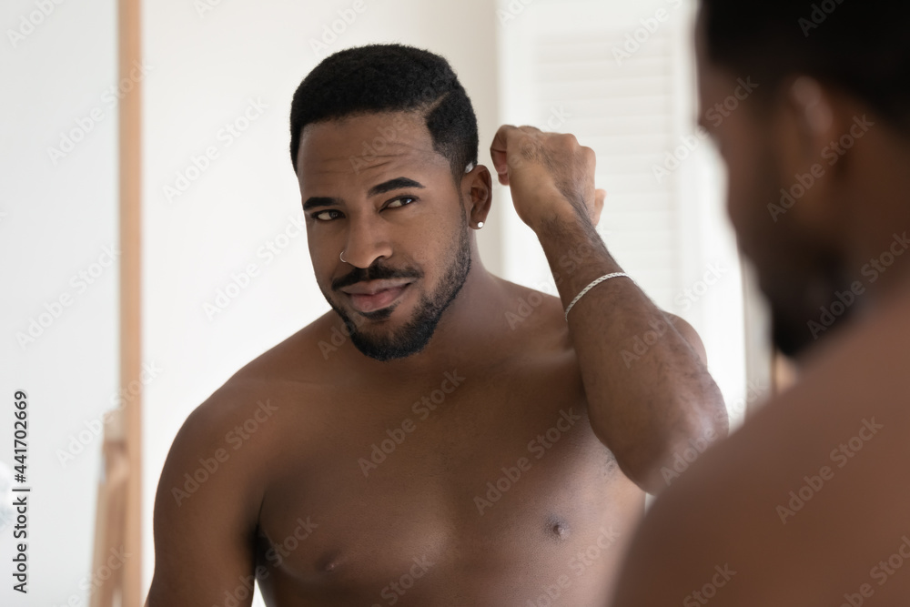Handsome young mixed race Black man with bare muscular torso, looking ...