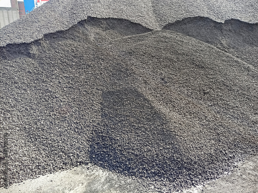 gravel on the dock ready to be loaded onto the ship.A pile of granite ...