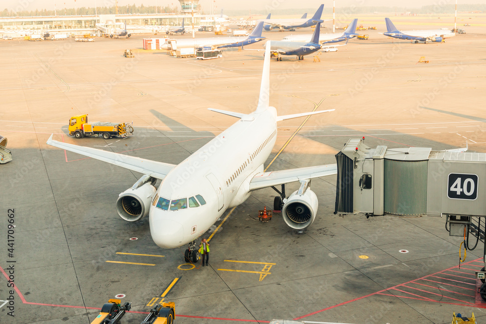 Plane on airport connected to gate sleeve. Aircraft and sleeve. Gate at ...