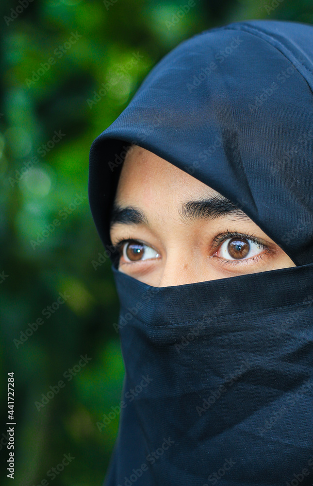 Closeup of beautiful woman face covered with hijab. Perfect shiny eyes ...
