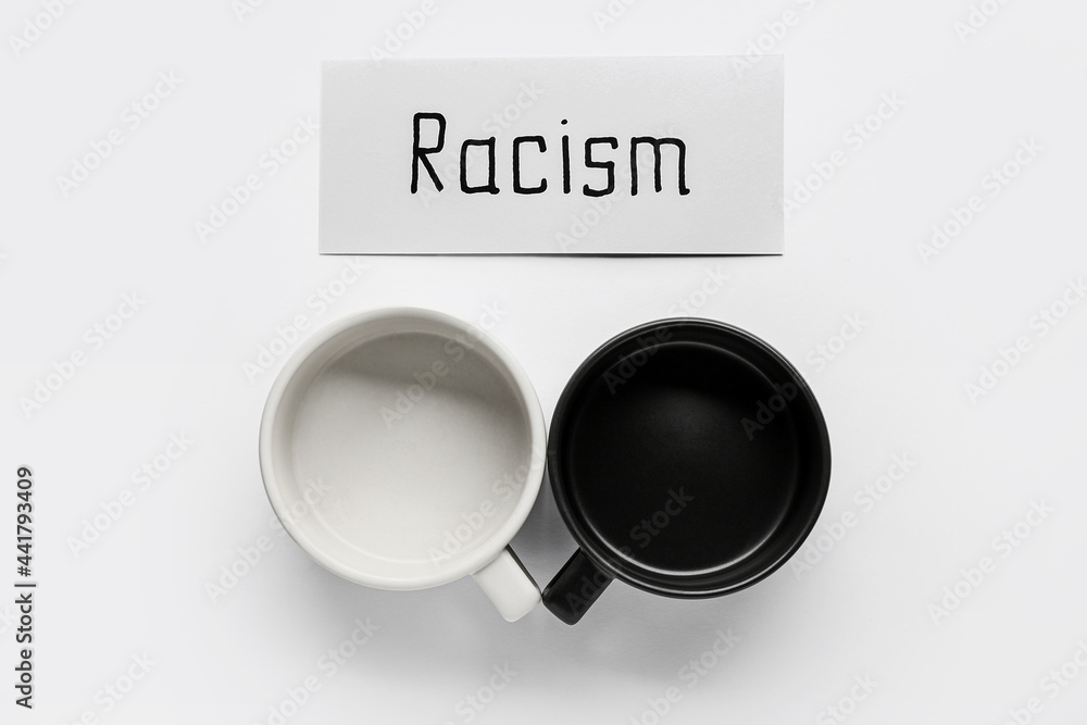 Paper piece with word RACISM and cups on white background Stock Photo ...