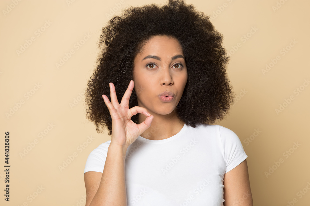 Headshot portrait of young African American woman isolated on yellow ...