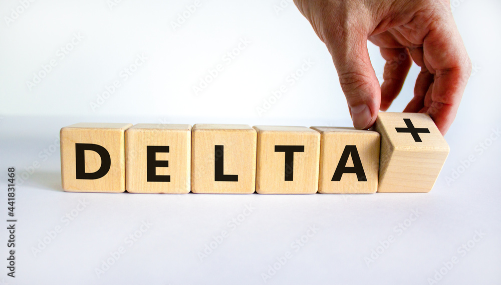 Covid-19 delta plus variant symbol. Doctor turns the wooden cube and ...