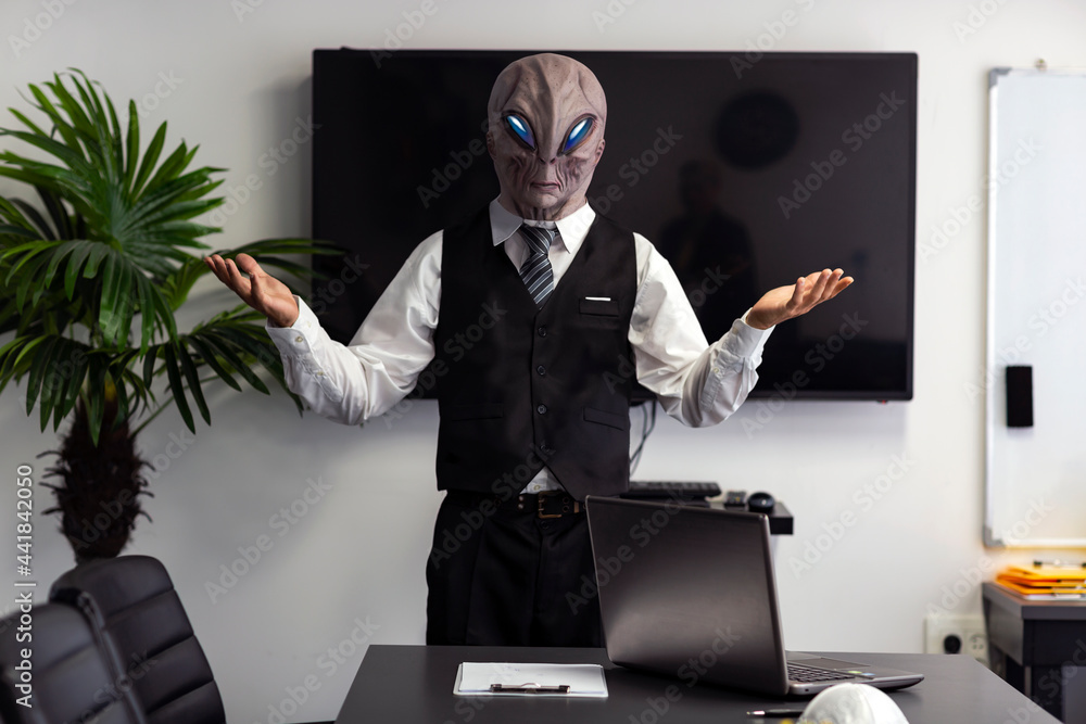 Surprised A humanoid Alien in a white shirt and business suit rising ...