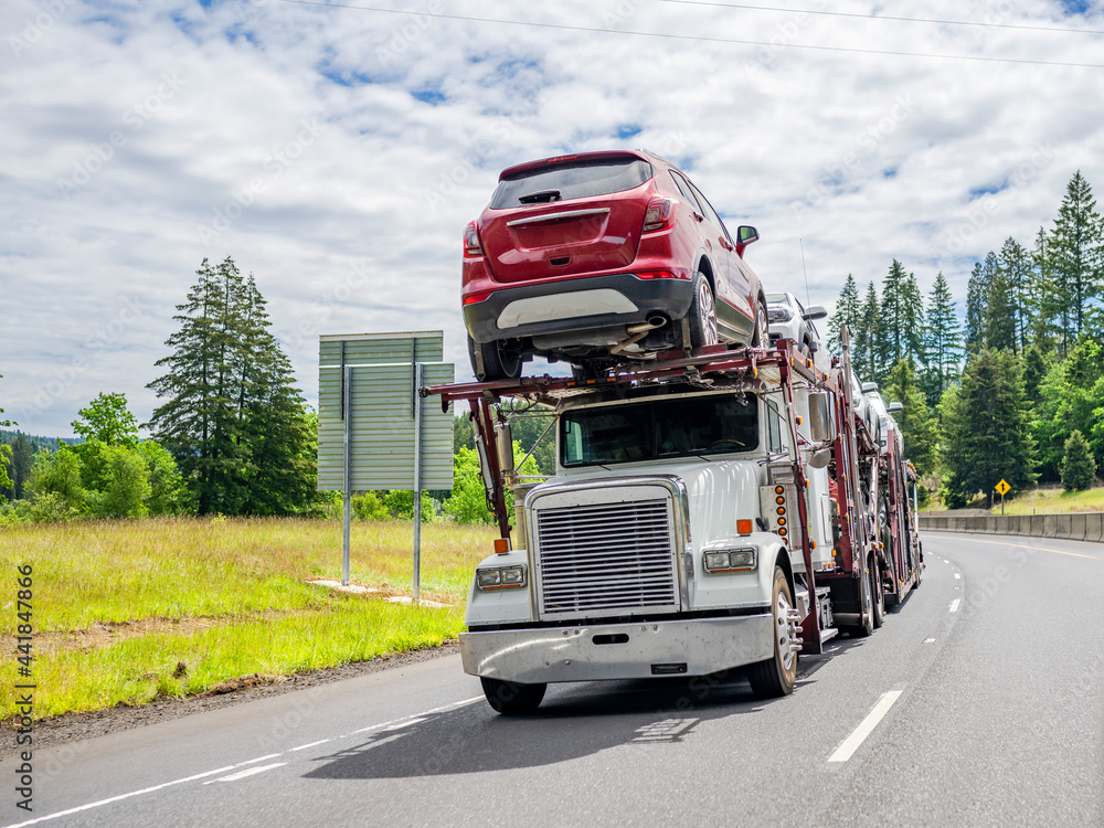 Capacious car hauler big rig semi truck transporting cargo on modular ...