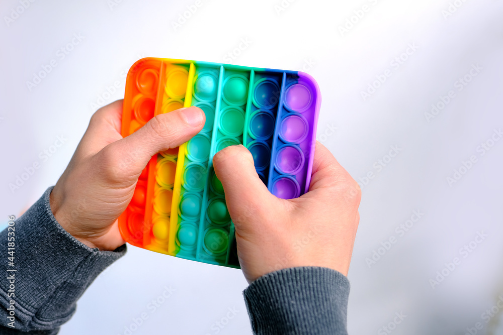 male hand holding a rainbow Toy antistress Pop it, poppit -new fidget ...