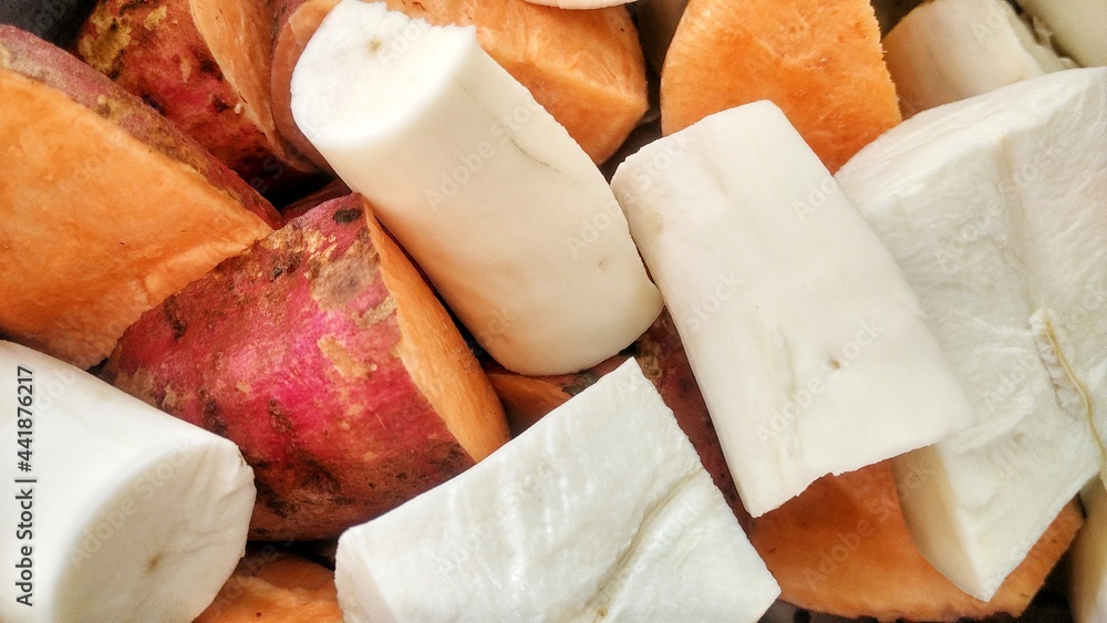 pieces of white cassava and orange pieces of red sweet potato, ready to ...