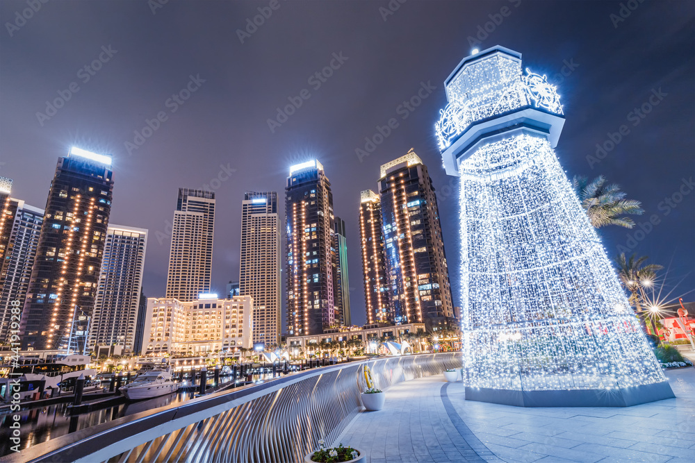 Illuminated decorative lighthouse near the parking lot of yachts and ...
