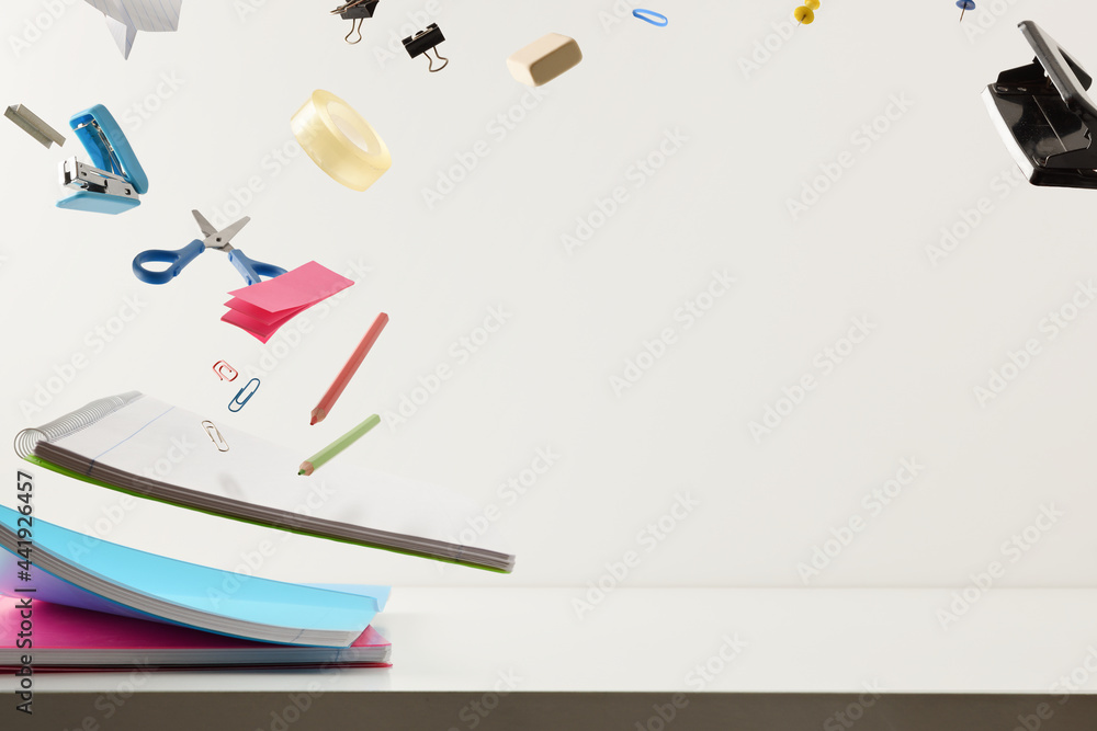 School supplies flying on desk white isolated background front Stock ...
