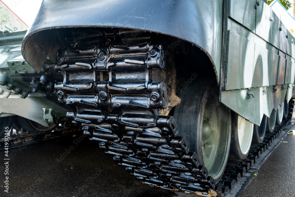Tracked armor close-up. Black tracks and large rubberized rollers. Tank ...