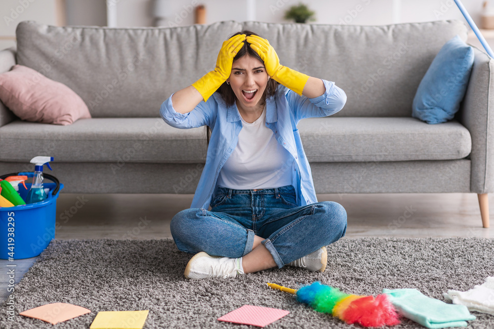 Screaming woman tired of cleaning sitting on floor carpet Stock Photo ...