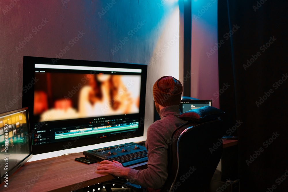 Attractive Male Video Editor Works with Footage or Video on His ...