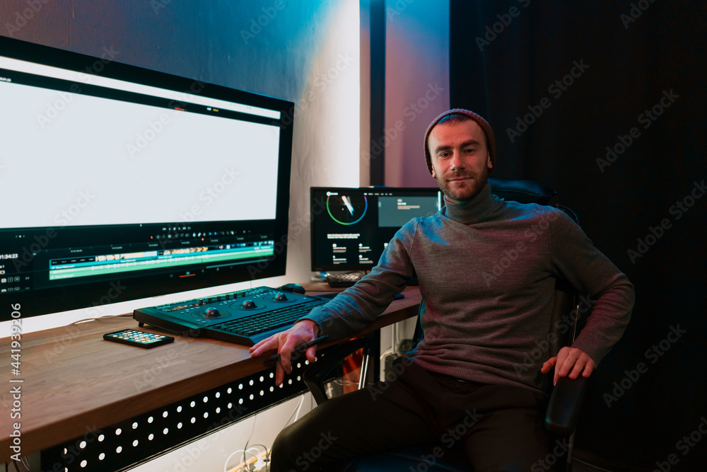 Attractive Male Video Editor Works with Footage or Video on His ...