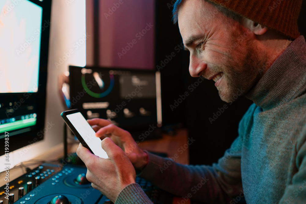 Attractive Male Video Editor Works with Footage or Video on His ...