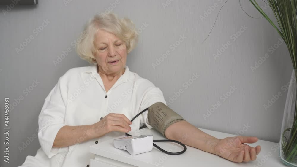 Everyday health check-up. Cheerful senior lady with hypertension ...