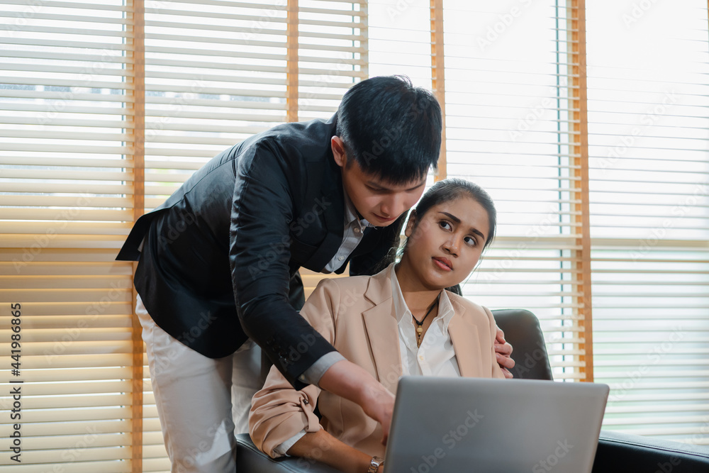 Unhappy asian young employee, employer colleague or boss touching at ...