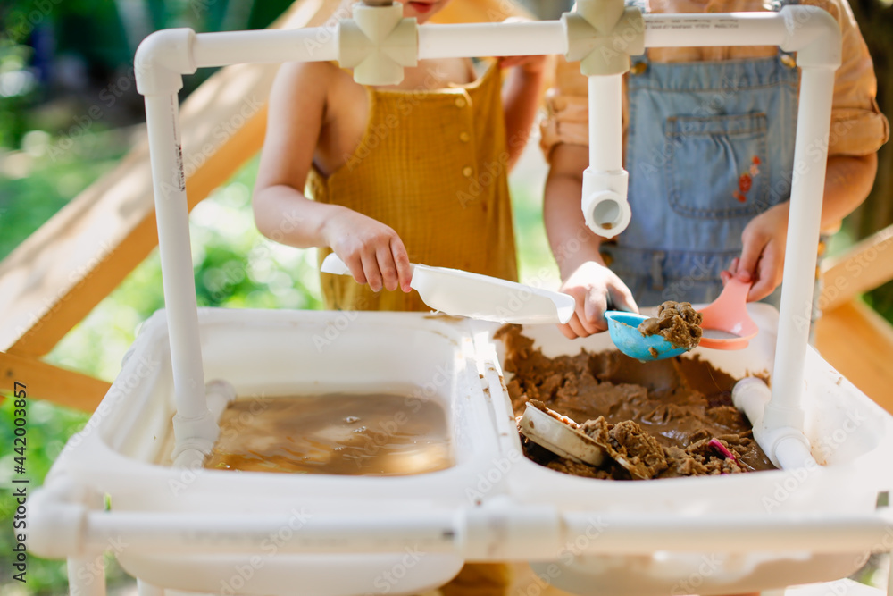 Happy children play with sand and water in sensory baskets on the ...