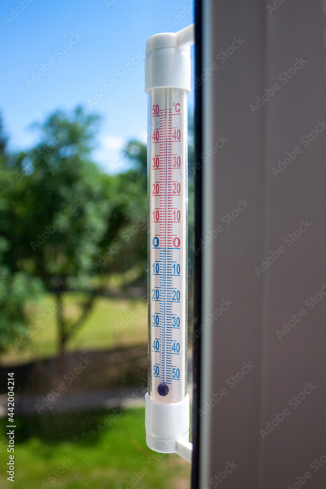A Celsius thermometer on a window frame shows high temperatures of 41.5 ...