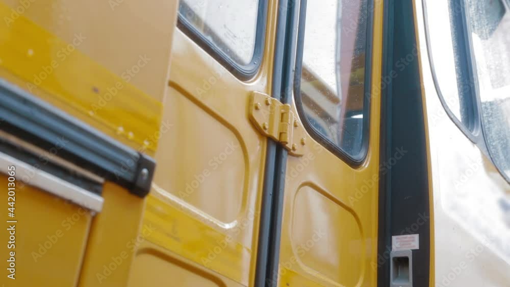 Doors of school bus closeing. Close up view of empty school bus on the ...