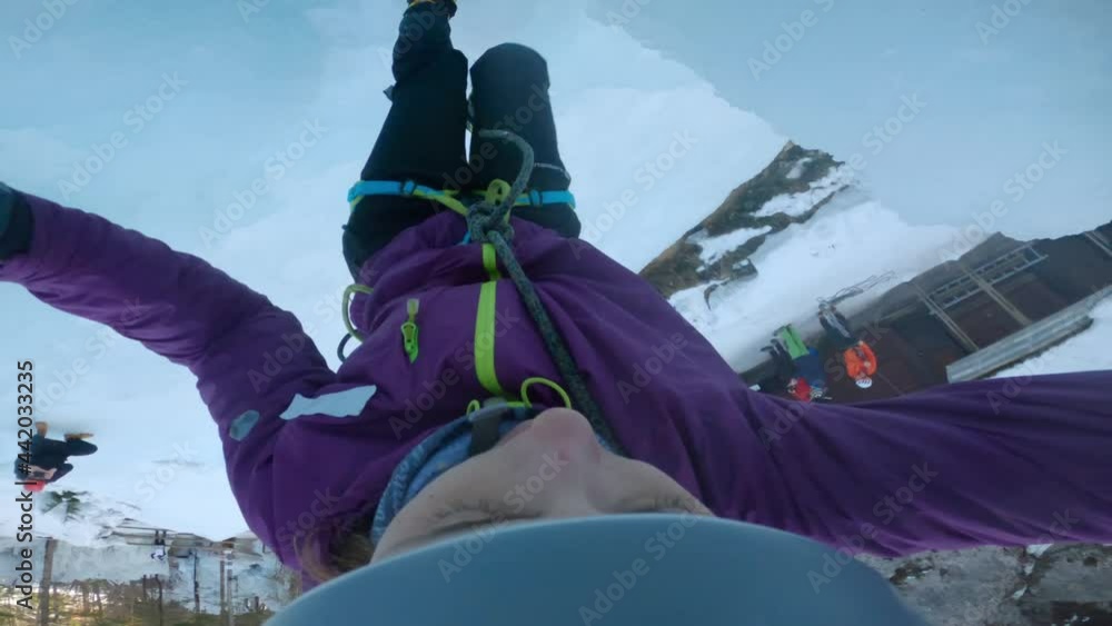Point of view of a female ice climber facing the slope, looking up and ...