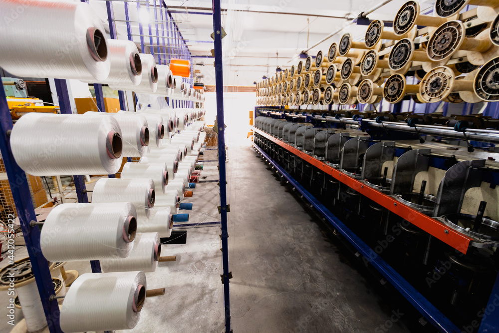 Rows and columns of Spindles and raw material in a factory, idle ...