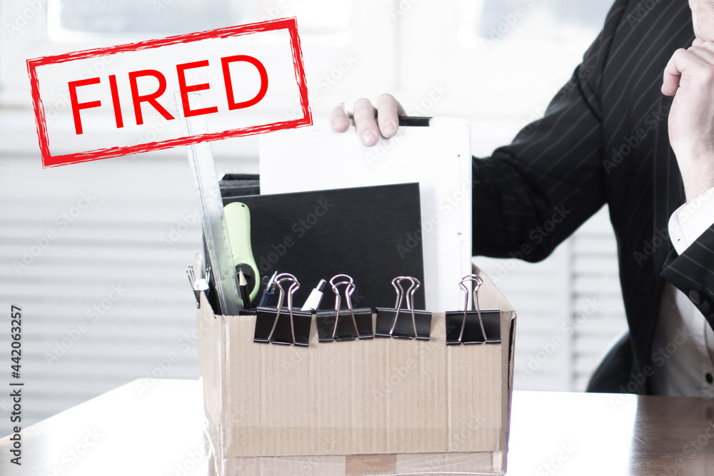Fired businessman holding a cardboard box. Fired businessman in his own ...