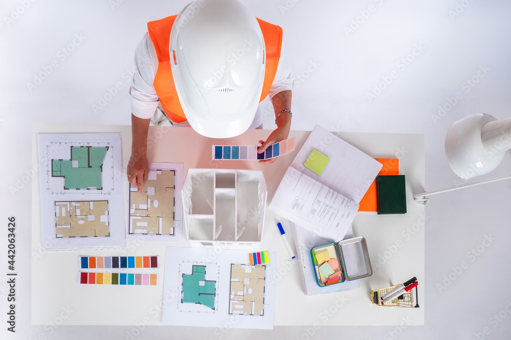 Interior designer at work. She works with architectural drawings. Woman ...