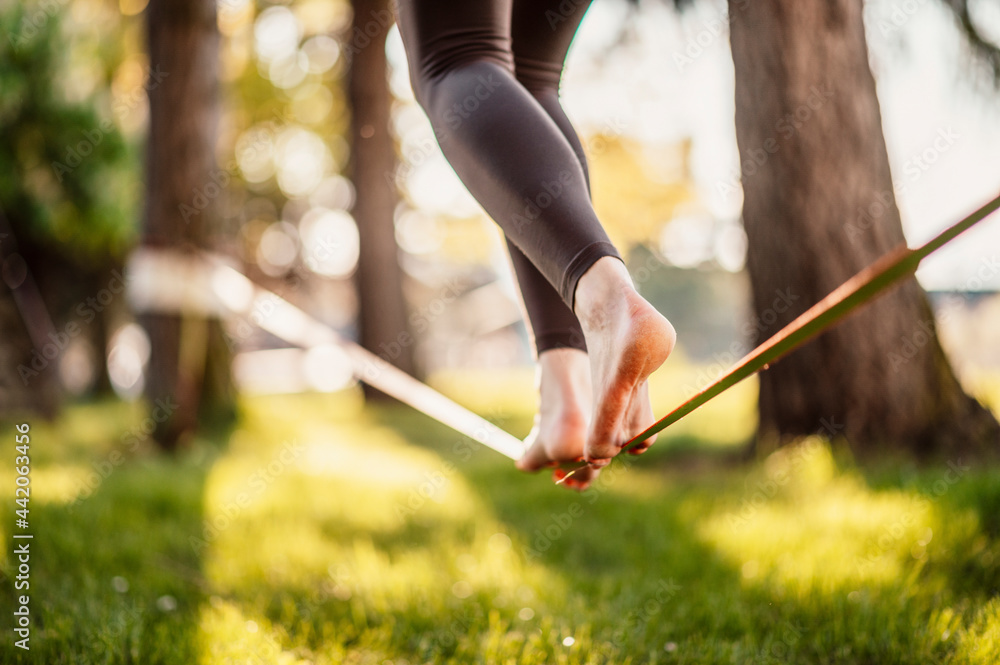 Slacklining is a practice in balance that typically uses nylon or ...