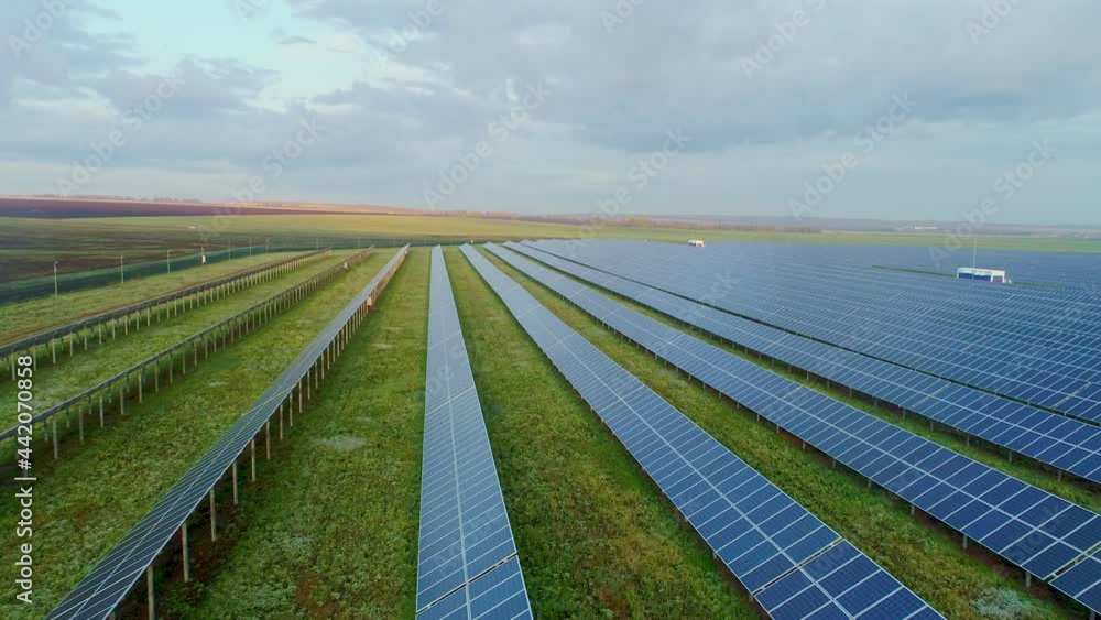 Solar panels at a suburban solar power plant. Farm fields on the ...