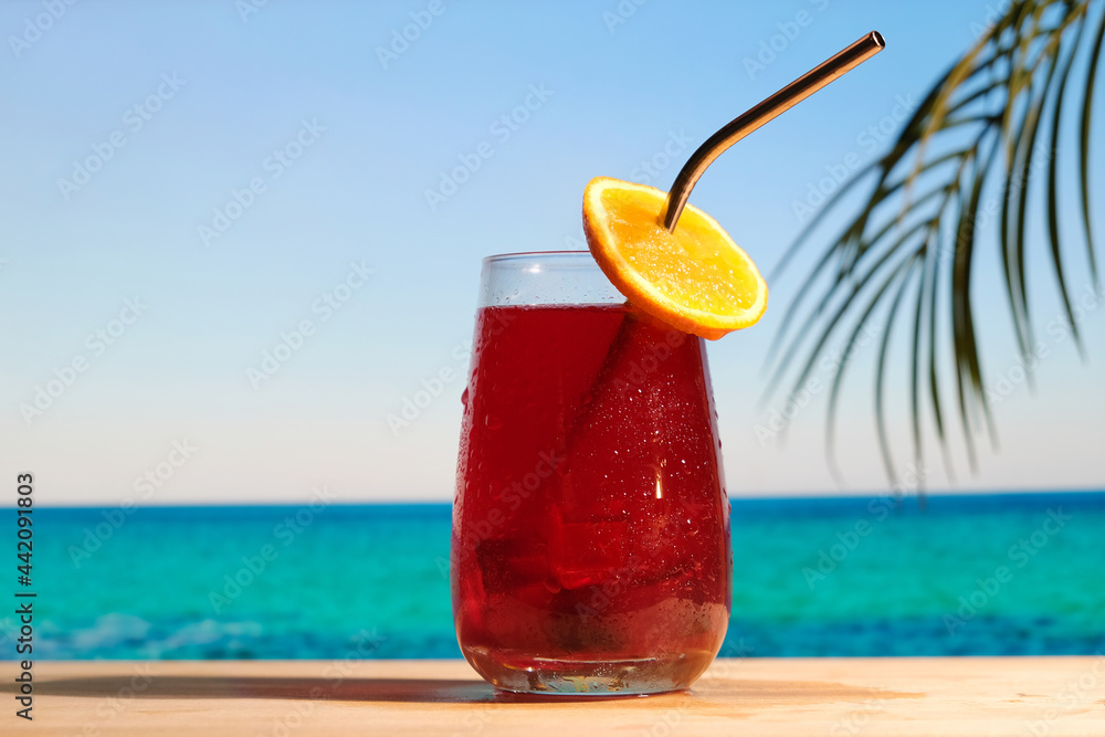 Rum cocktail with cranberry juice on the tropical beach. Glass of ...