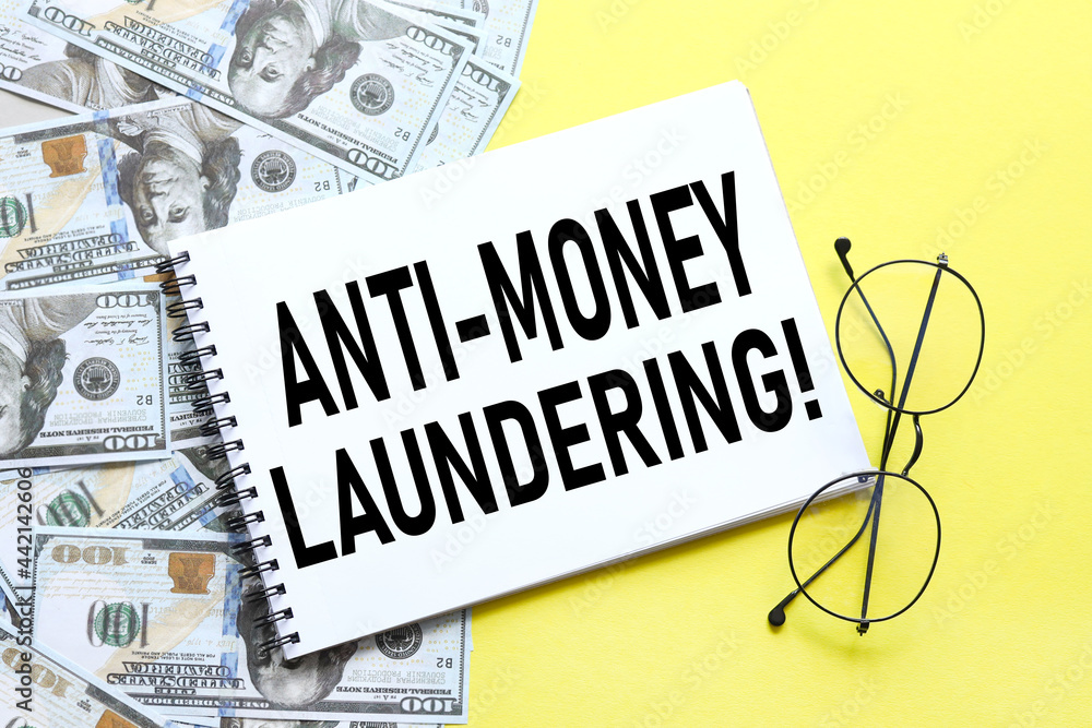 Anti-money laundering AML. background with money, dollar bills and ...