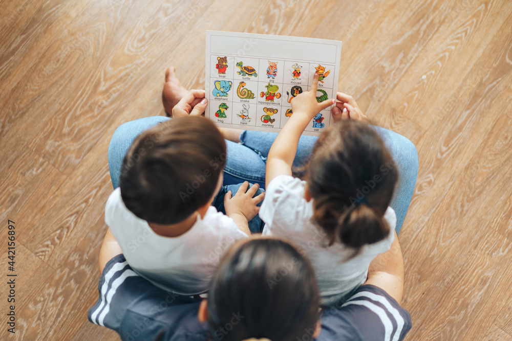 Mom and children call animals from educational cards Stock Photo ...