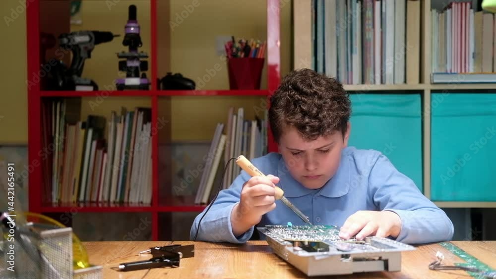 Child repairs chip and solders printed circuit board with soldering ...