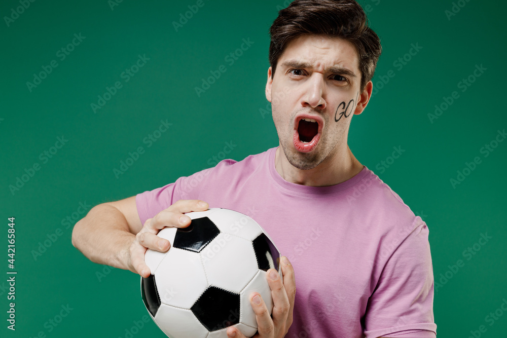 Young fun european man fan supporter wears basic pink t-shirt cheer up ...