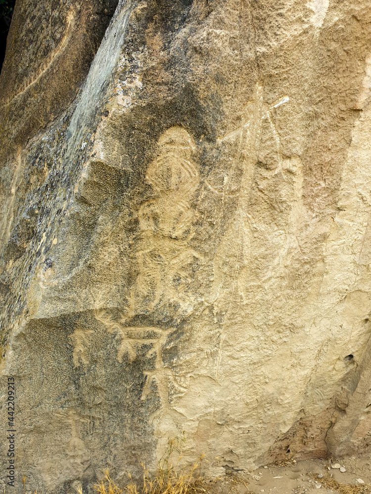 Ancient rock carvings petroglyphs of people with boat in Gobustan ...