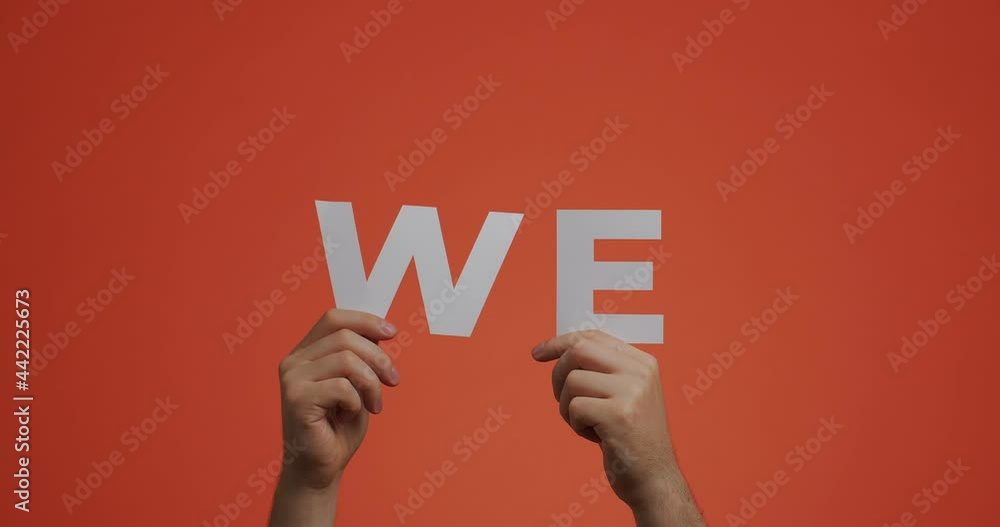 Hands raising up showing word we of english language. Man shows pronoun ...