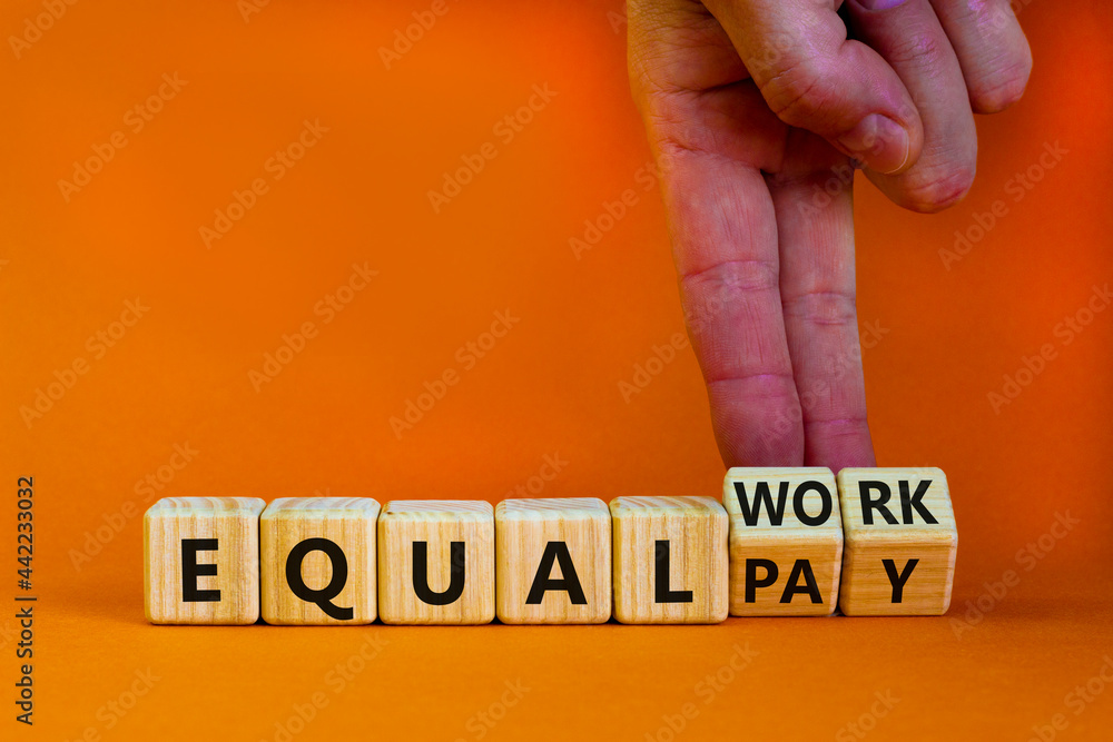 Equal pay and work symbol. Businessman turns wooden cubes and changes ...