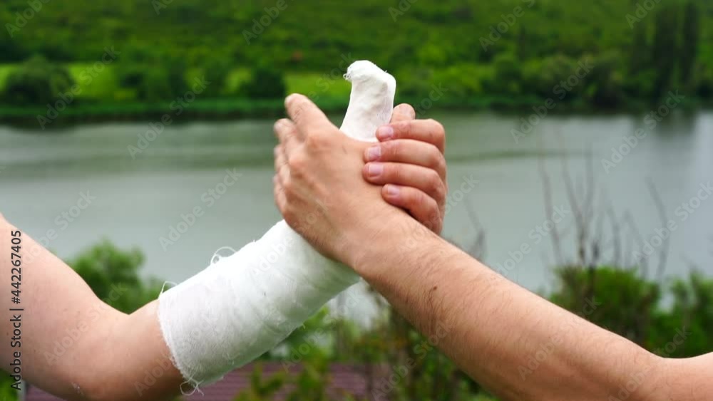 Video Stock Friendly handshake of two men on nature background in ...