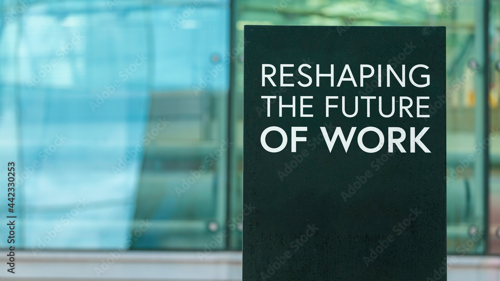 Reshaping the future of work on a city-center sign in front of a modern ...