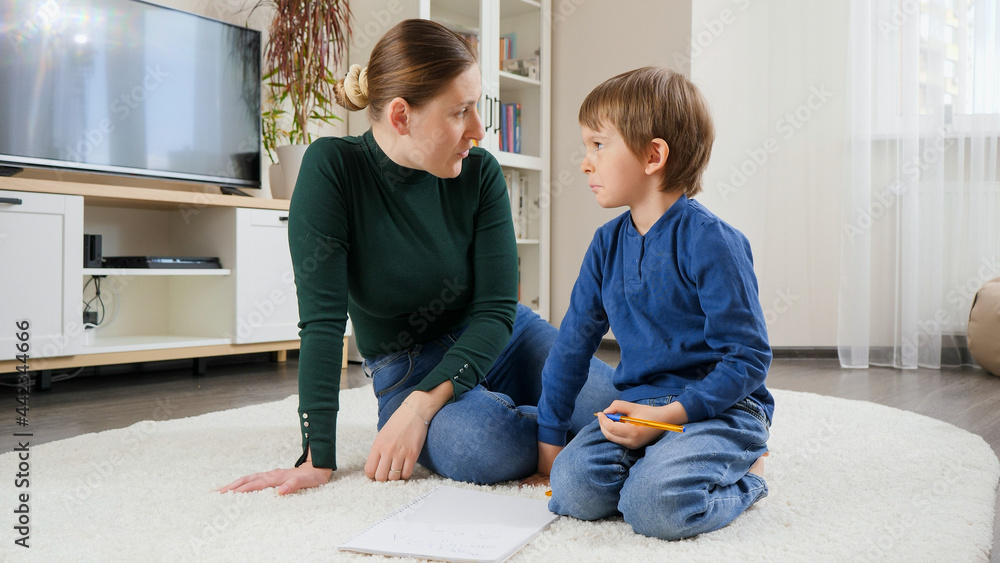 Young displeases mother shouting and talking strictly to her son doing ...