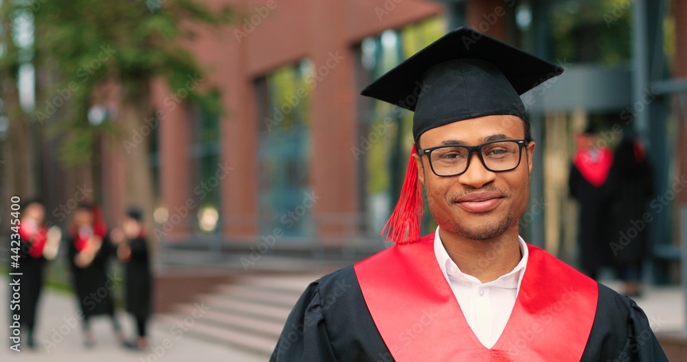 Young graduated boy holding his graduation degree convocation ceremony ...