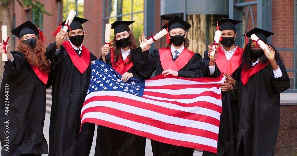 Young graduated people holding their graduation degree convocation ...