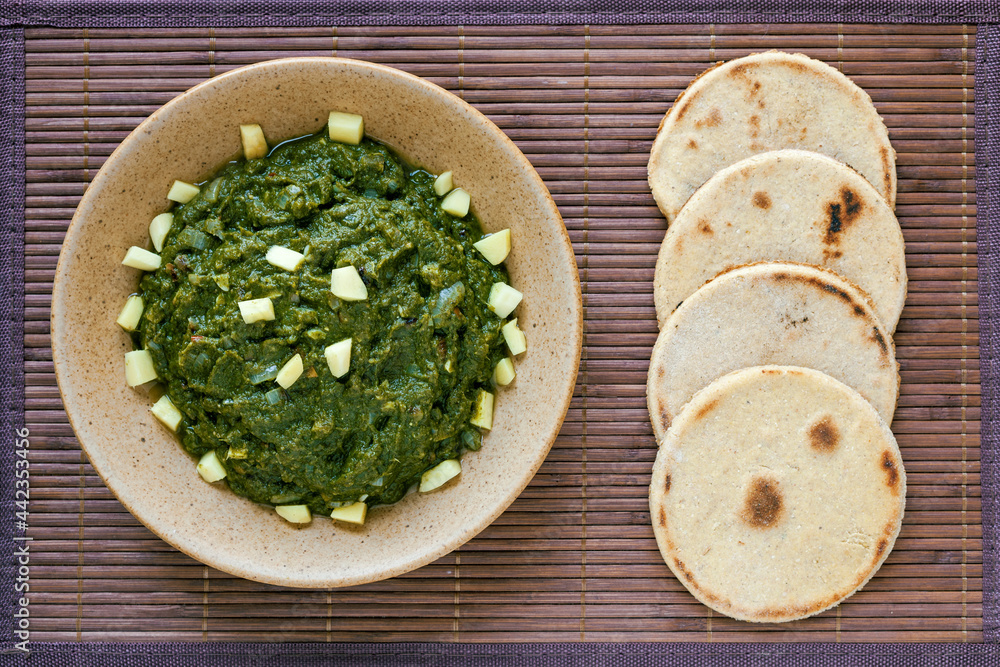 Mustard greens dish with corn roti flatbreads. Vegan Indian meal (Makki ...