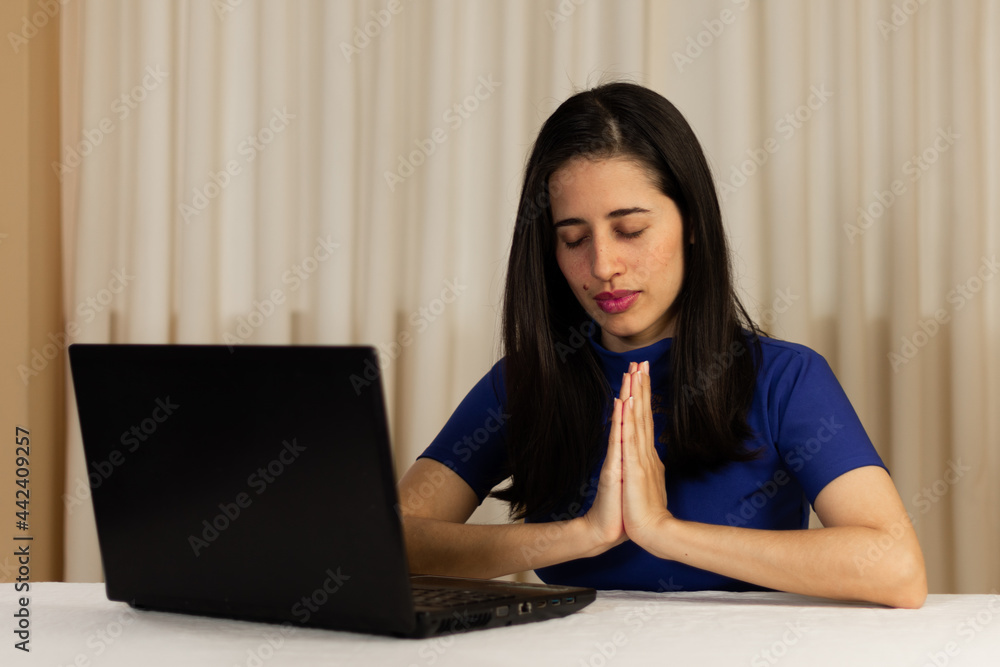 Christian and religious woman in front of the computer. virtual worship ...