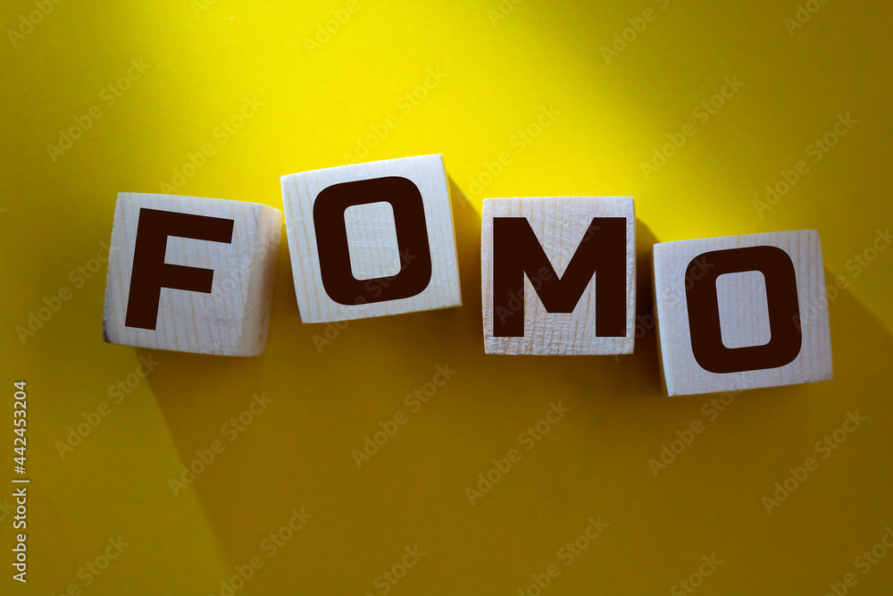 Fotografia do Stock: FOMO, acronym for Fear of Missing Out in wooden ...