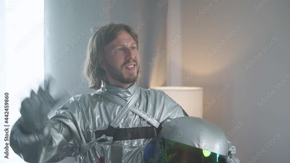 Spaceman, middle-aged man in an astronaut suit stands in living room ...