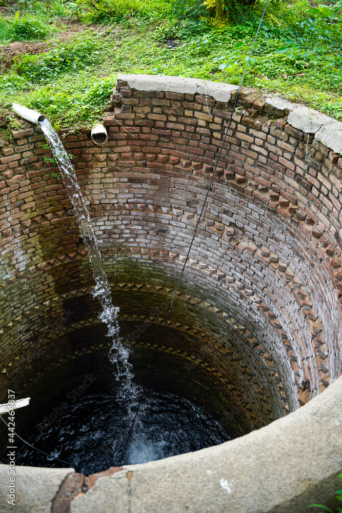 Irrigation water flow from pipe to canal for agriculture fields. Stock ...