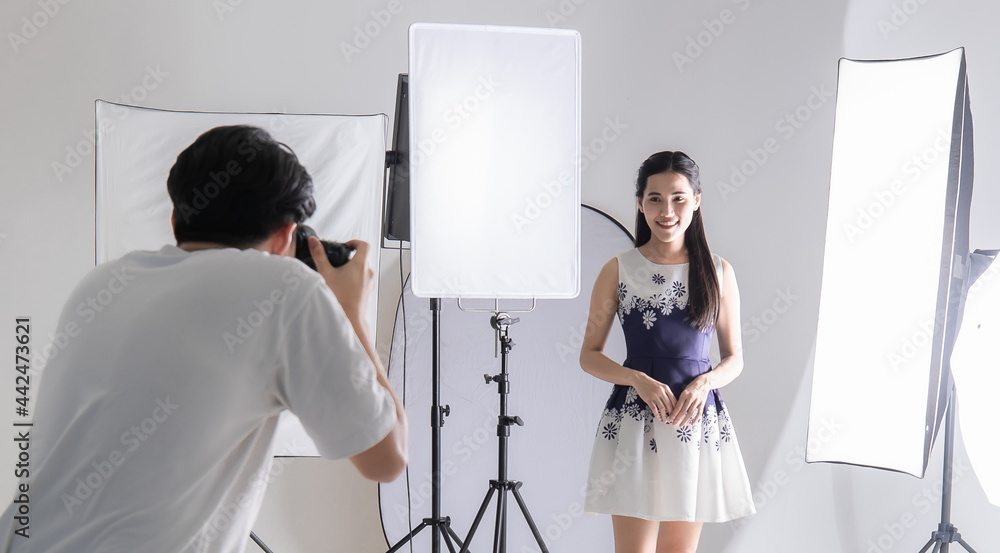 Asian man photographer and model woman taking pictures With dslr camera ...