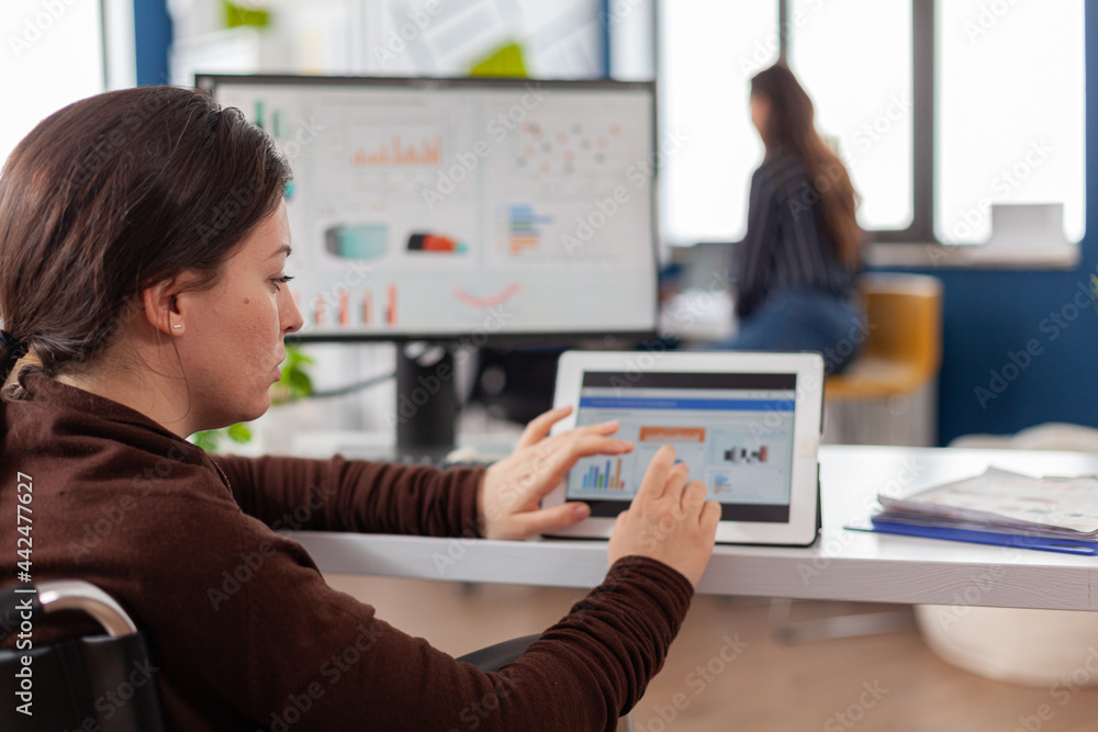 Invalid paralysed handicapped woman entrepreneur using computer and ...