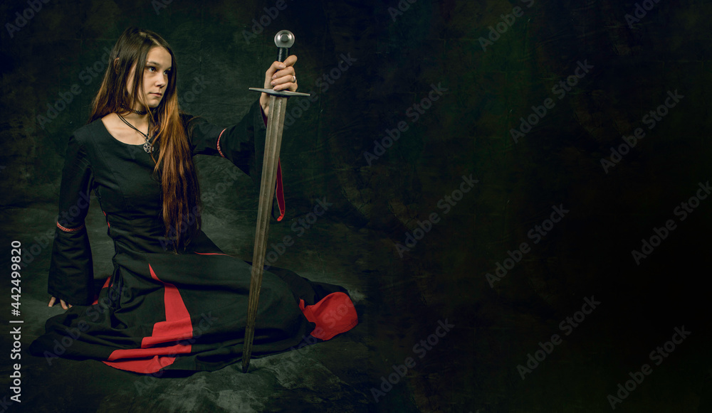 full length portrait of young long haired woman wearing medieval ...